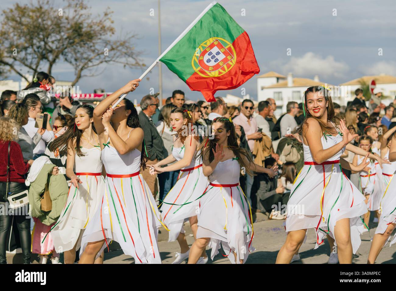 Altura, Portugal, March 2, 2025. Women in white dresses with colorful ...