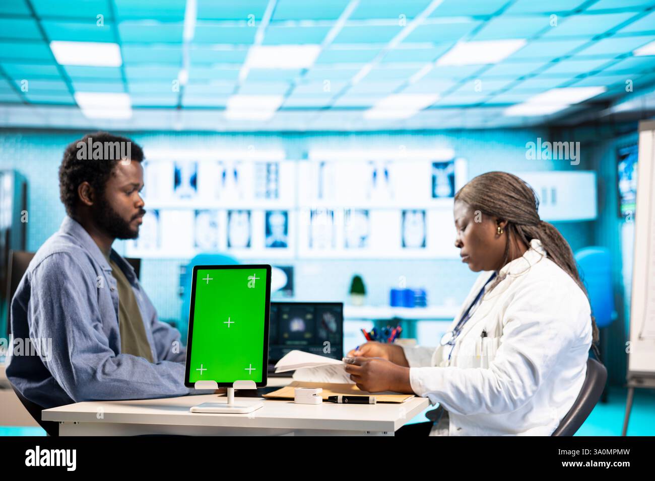 Black medic meets with patient next to isolated mockup display at the ...