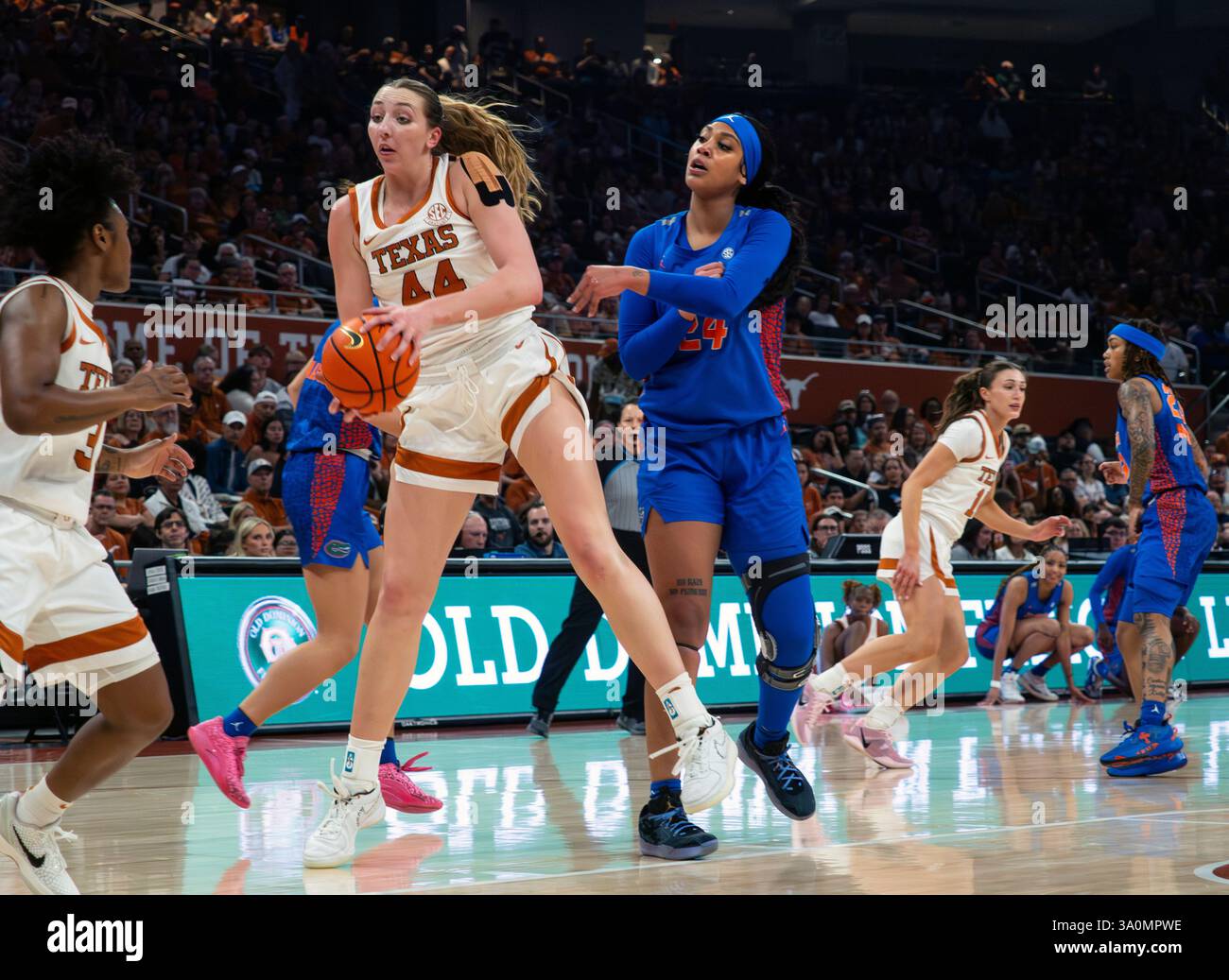 Texas forward Taylor Jones, left, brings down a rebound against Florida ...