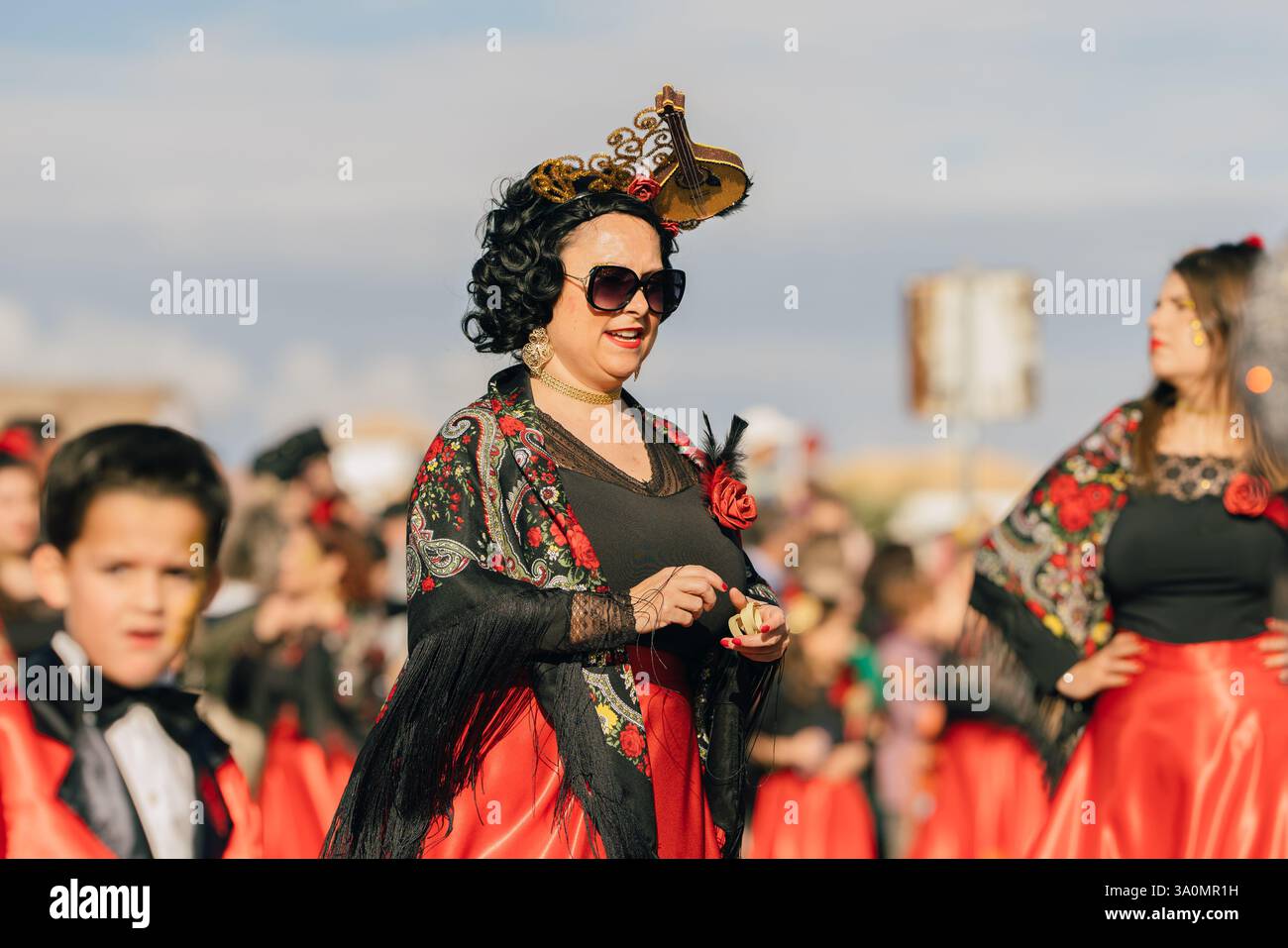 Altura, Portugal, March 2, 2025. A woman in a black and red traditional ...