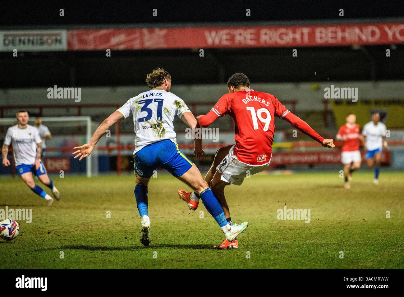 Morecambe FC's Marcus Dackers tries a shot under pressure from Joe ...