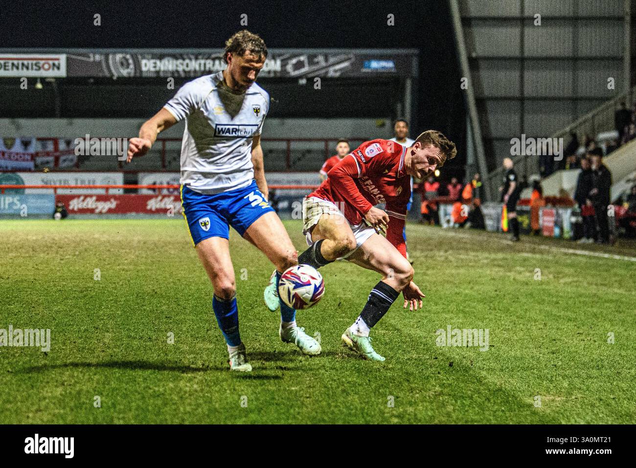 Joe Lewis of AFC Wimbledon tackles Morecambe FC's Ged Garner during the ...