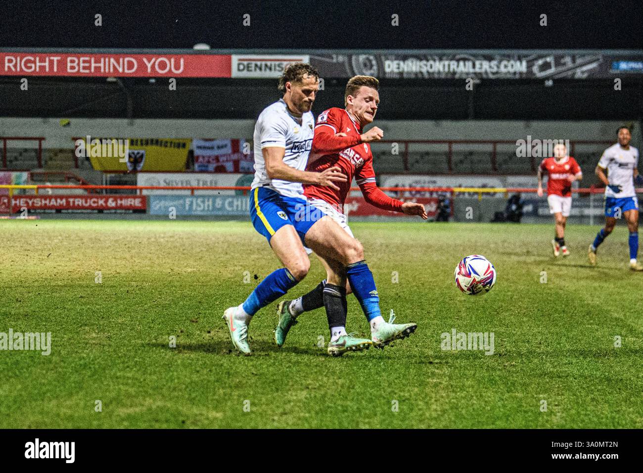 Joe Lewis of AFC Wimbledon tackles Morecambe FC's Ged Garner during the ...
