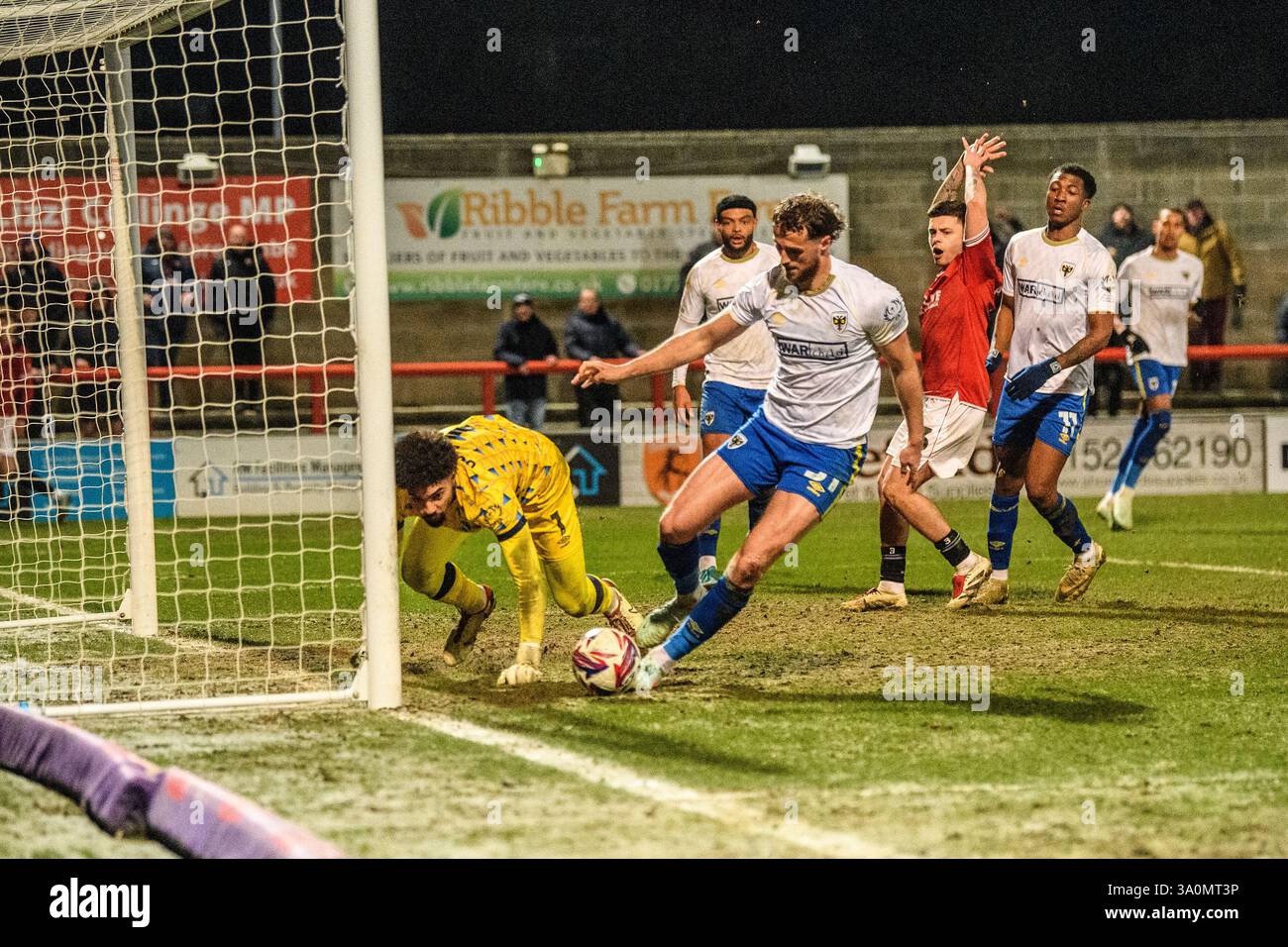 Joe Lewis of AFC Wimbledon saves the ball from going over the touchline ...