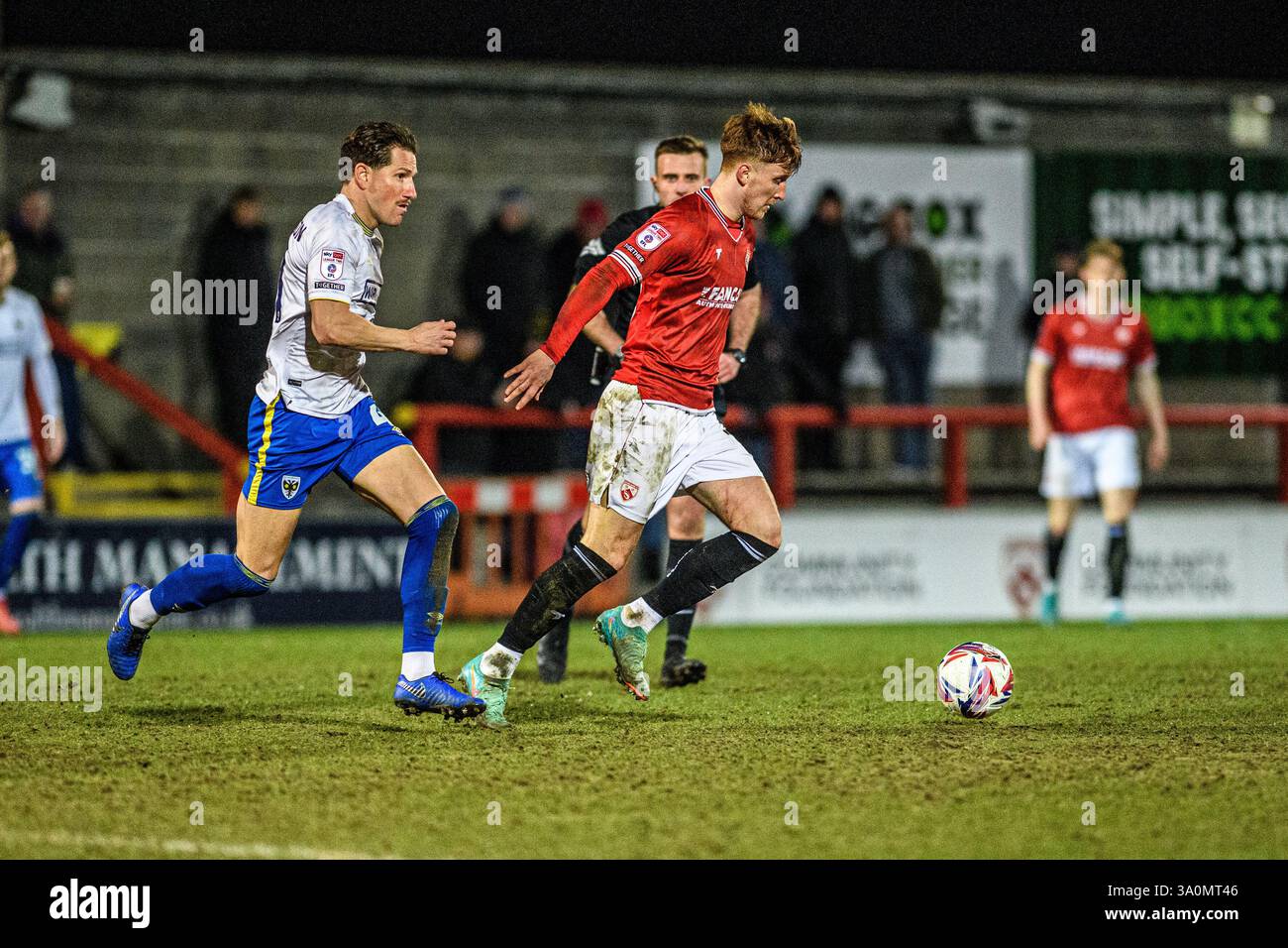 Morecambe FC's Ross Millen under pressure from Sam Hutchinson of AFC ...