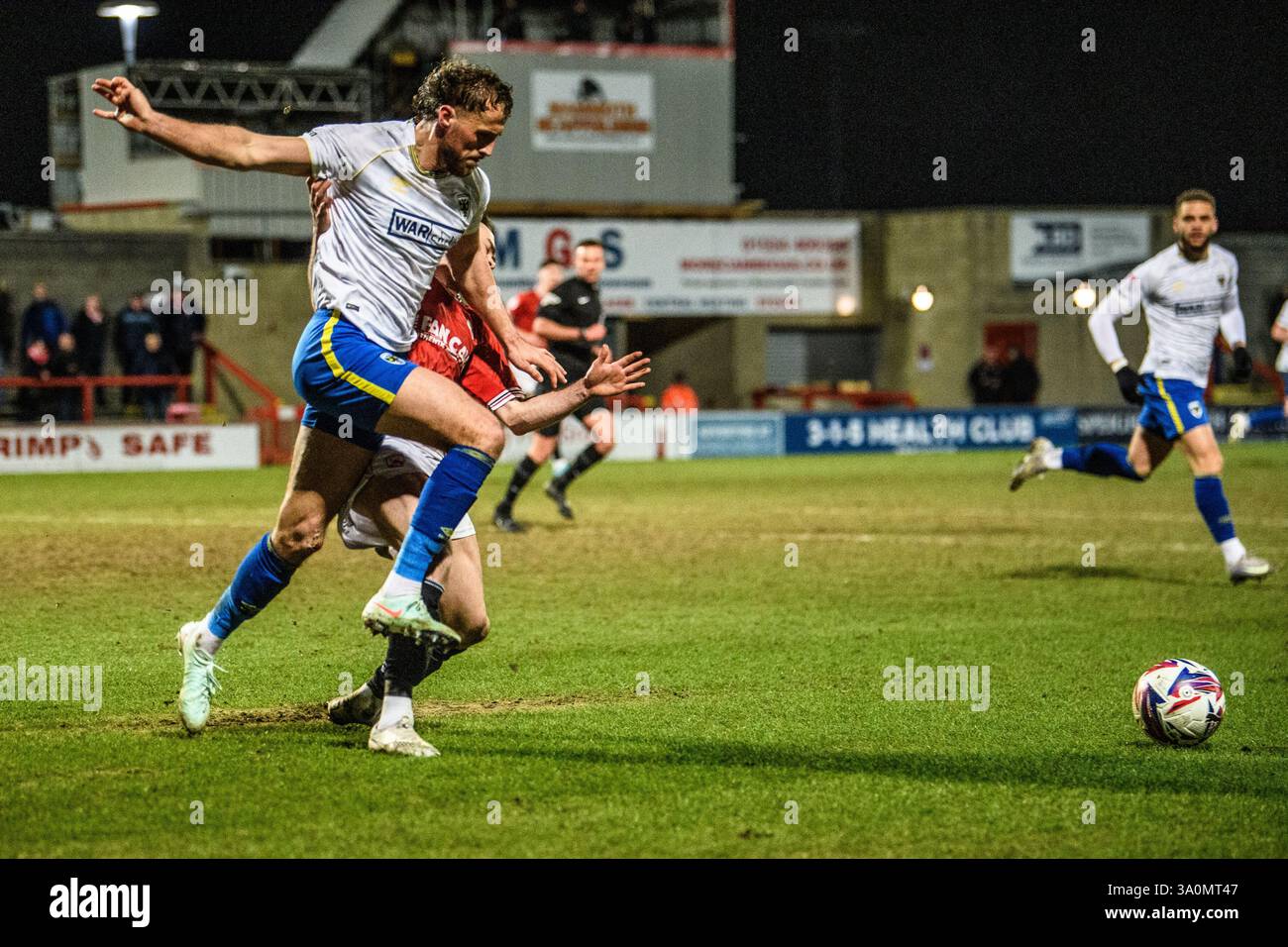 Morecambe FC's Gwion Edwards tackles Joe Lewis of AFC Wimbledon during ...