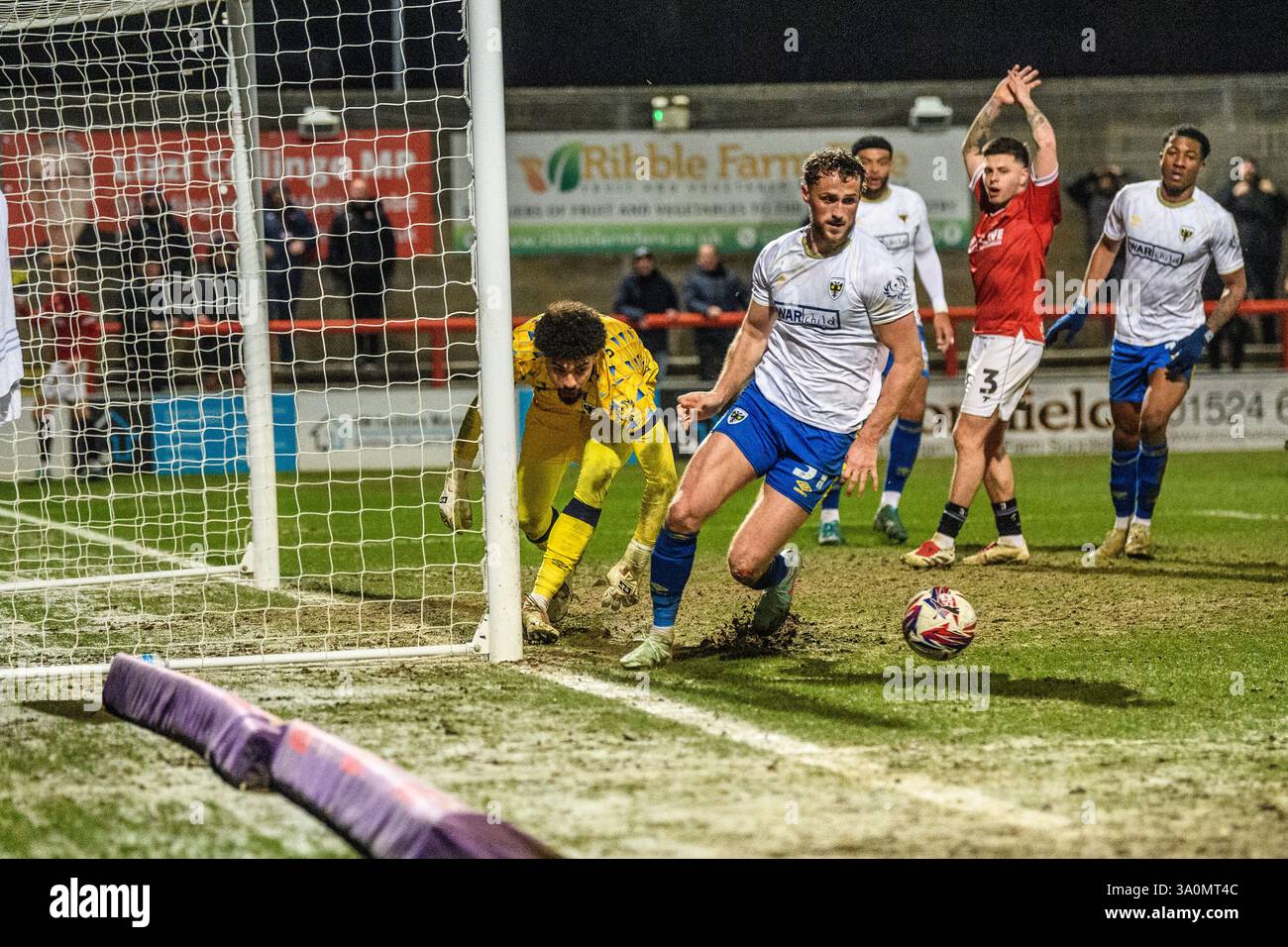 Joe Lewis of AFC Wimbledon saves the ball from going over the touchline ...