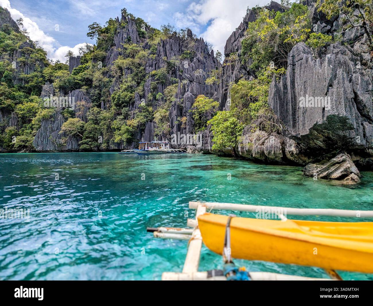 Turquoise waters of Coron Island, Philippines, with a yellow kayak in ...