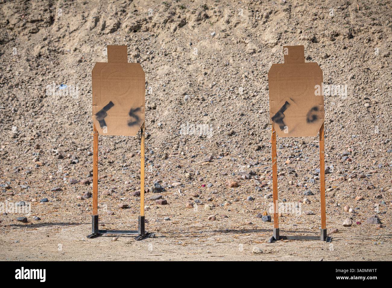 Pair of clean cardboard silhouette targets with black gun-shaped ...