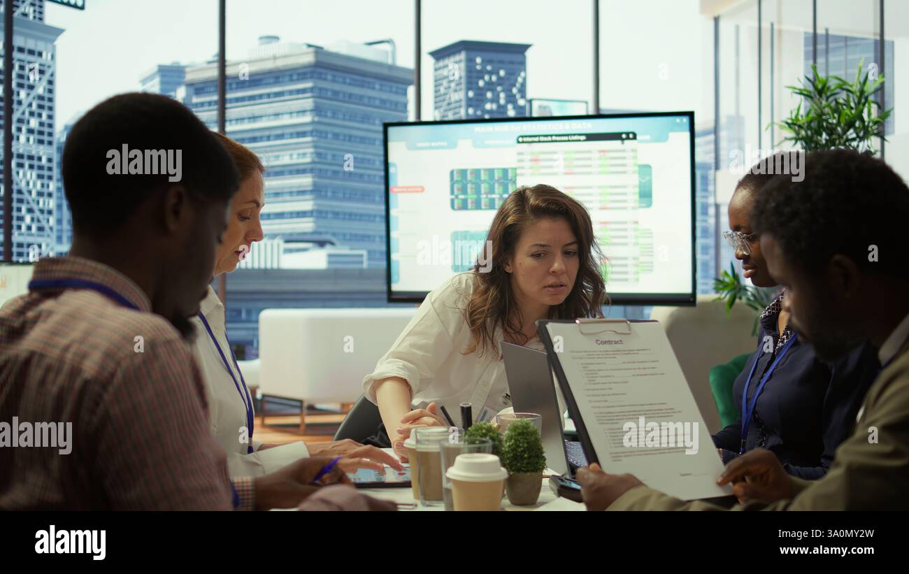 Financial expert showing statistics data on papers in a conference room ...