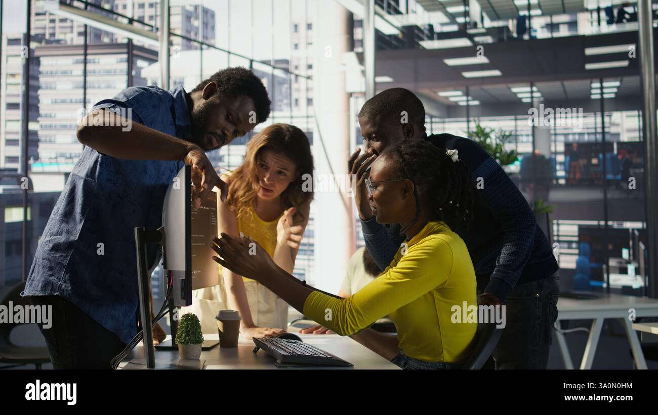 Upset IT workers in office debating, doing brainstorming, looking through lines of code on ...