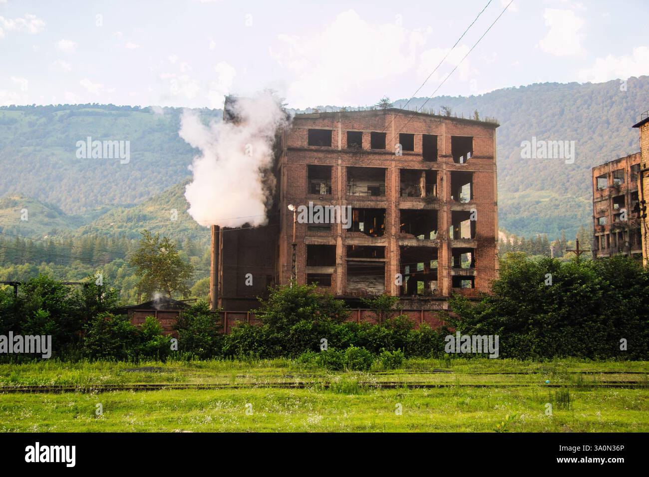 Burnt ruined industrial building, consequences of attack concept Stock ...