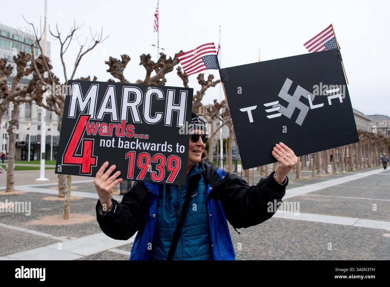 San Francisco, USA. 4th Mar 2025. A woman joins protesters at Civic ...
