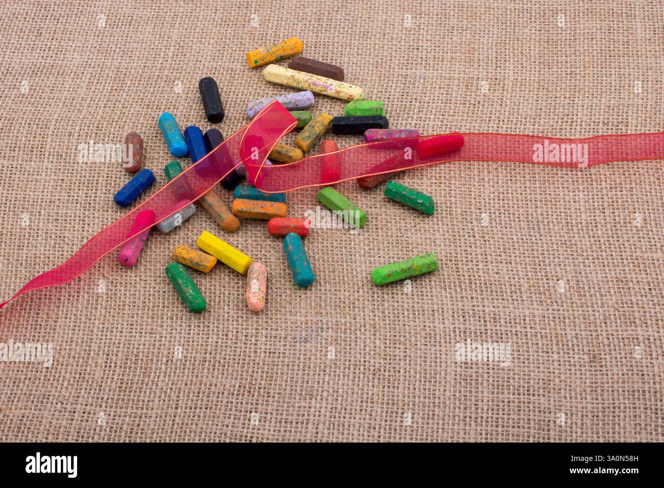 Used crayons of various color wirh a ribbon Stock Photo - Alamy