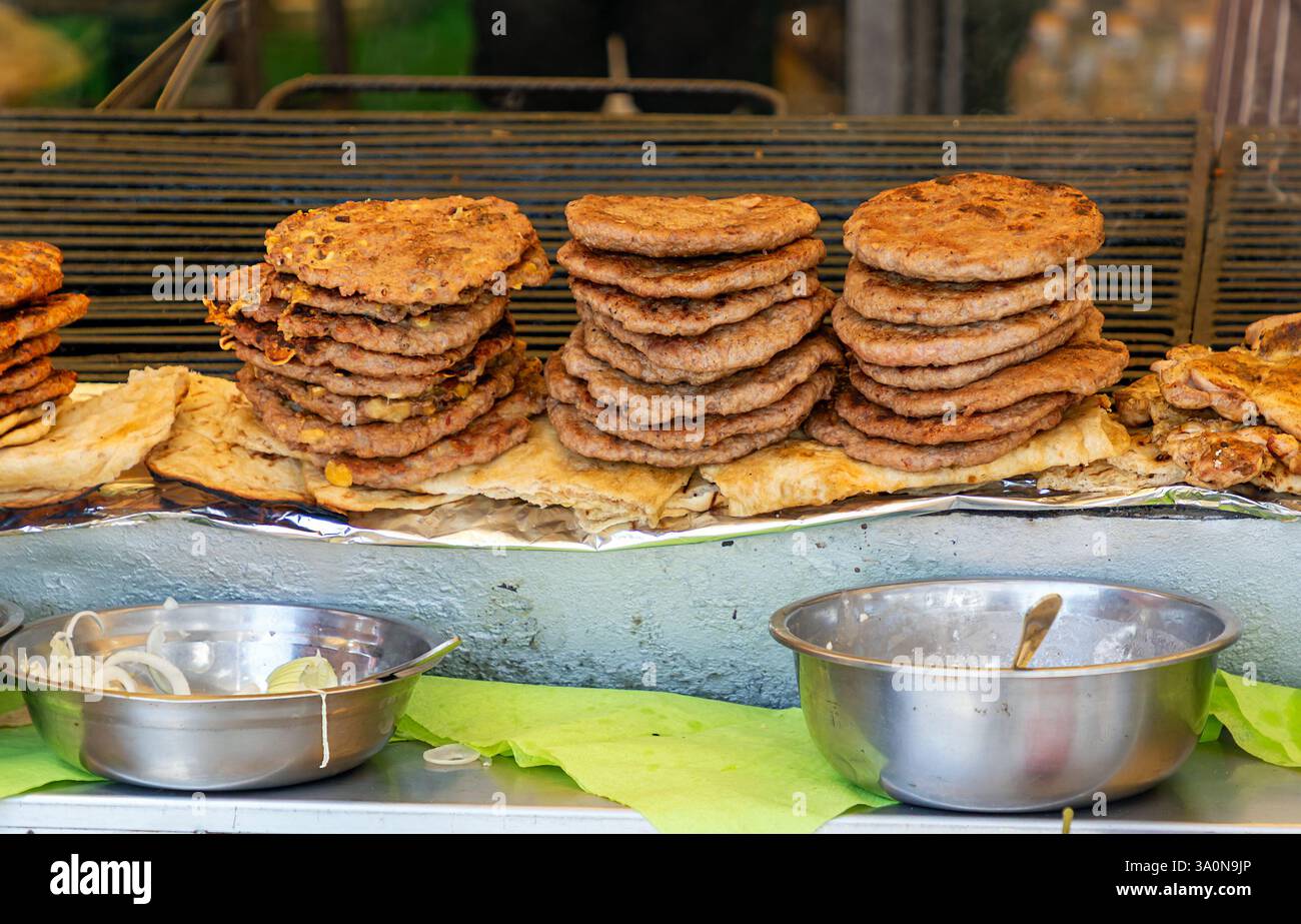 Stack of beef burgers on market grill outside Stock Photo - Alamy