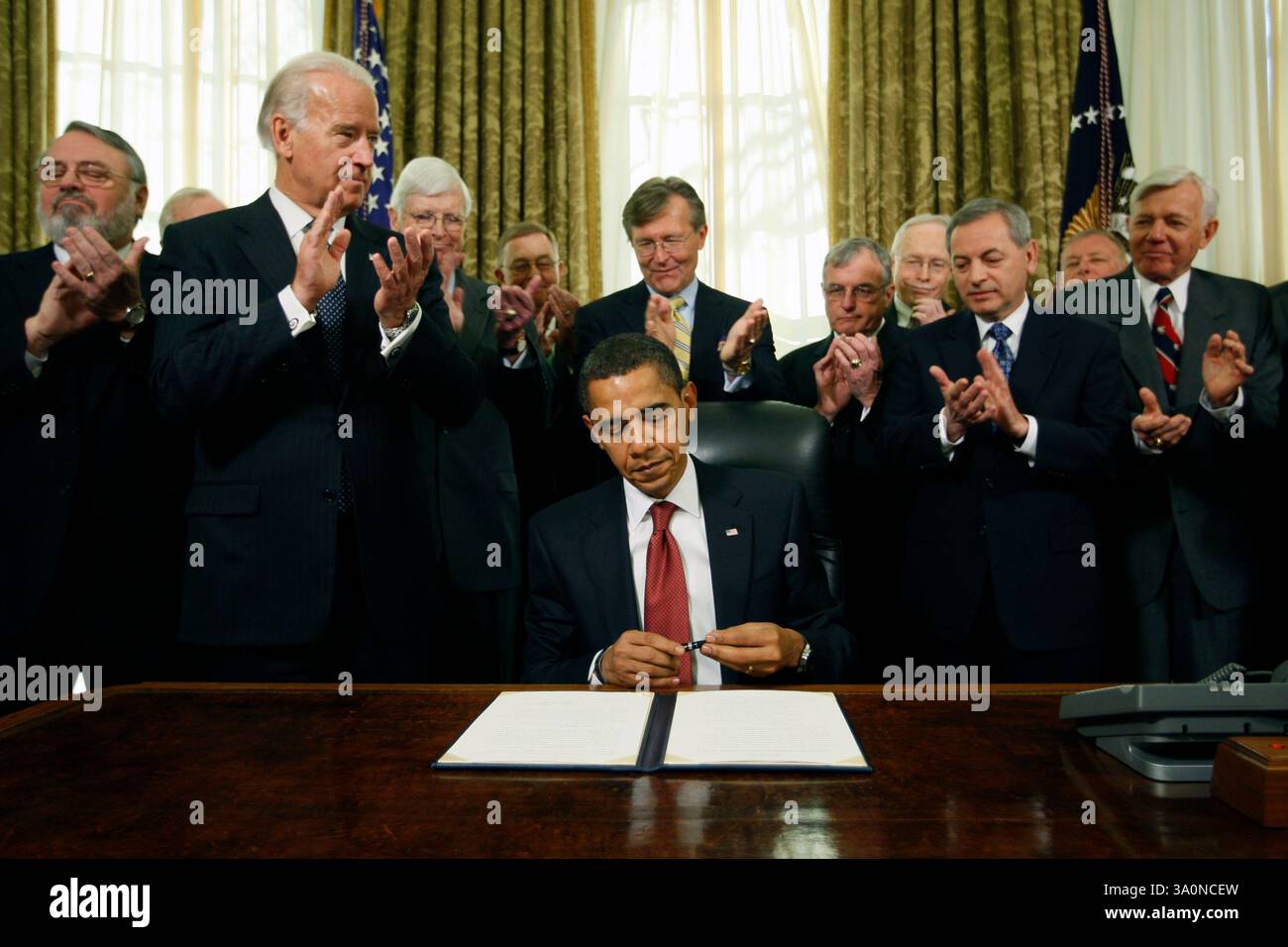 President Barack Obama caps his pen after he signed an executive order ...