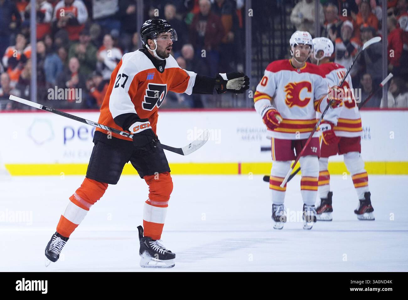 Philadelphia Flyers' Noah Cates, left, reacts after scoring a goal ...