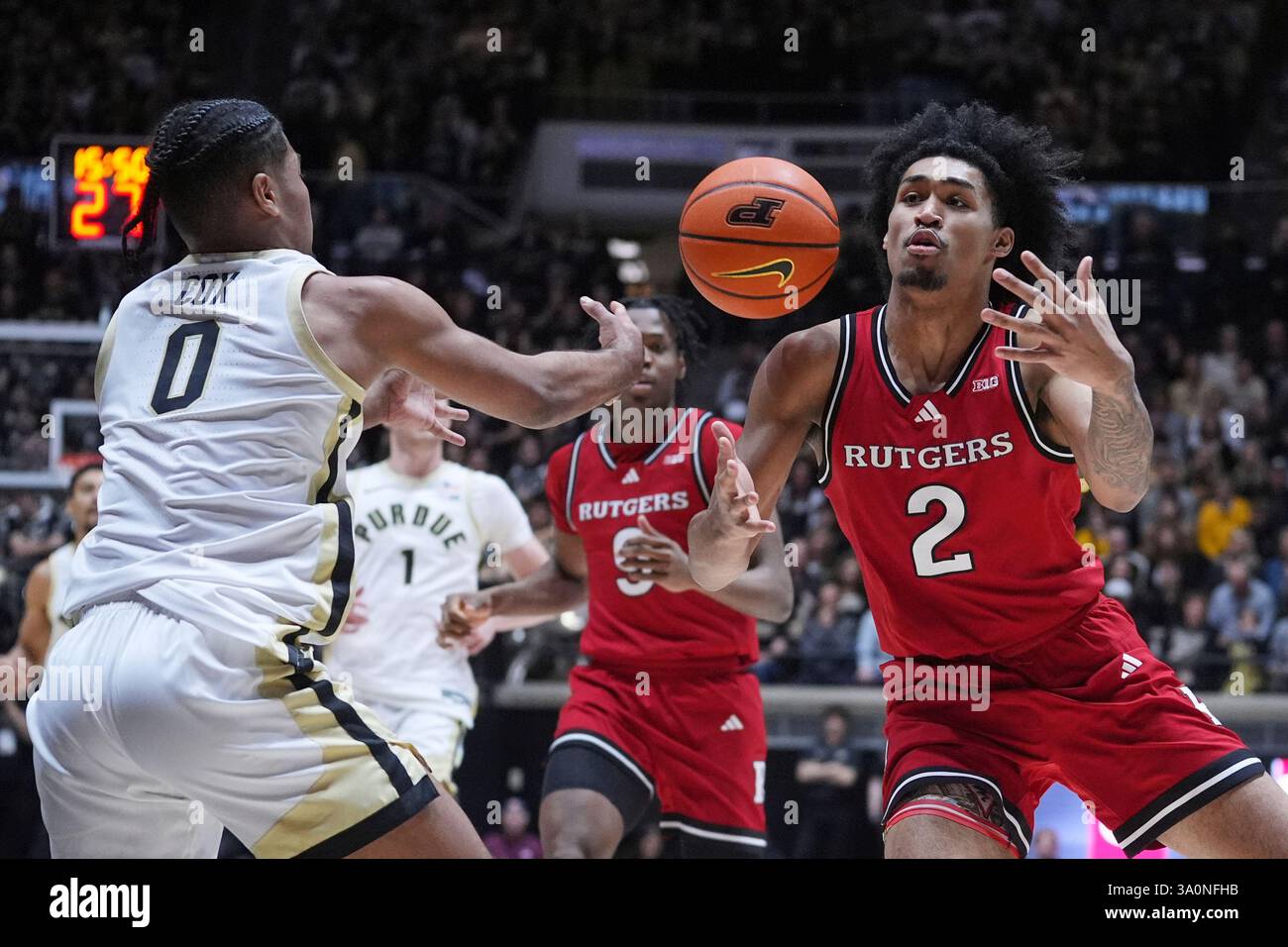 Rutgers guard Dylan Harper (2) looses the ball in front of Purdue guard ...