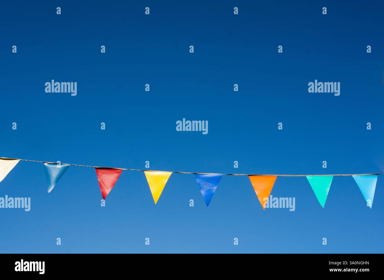 Colorful triangle bunting flags of various colors as festival concep ...