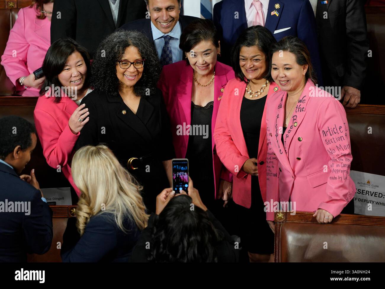 Members of the Democratic Women's Caucus wear pink in protest as ...