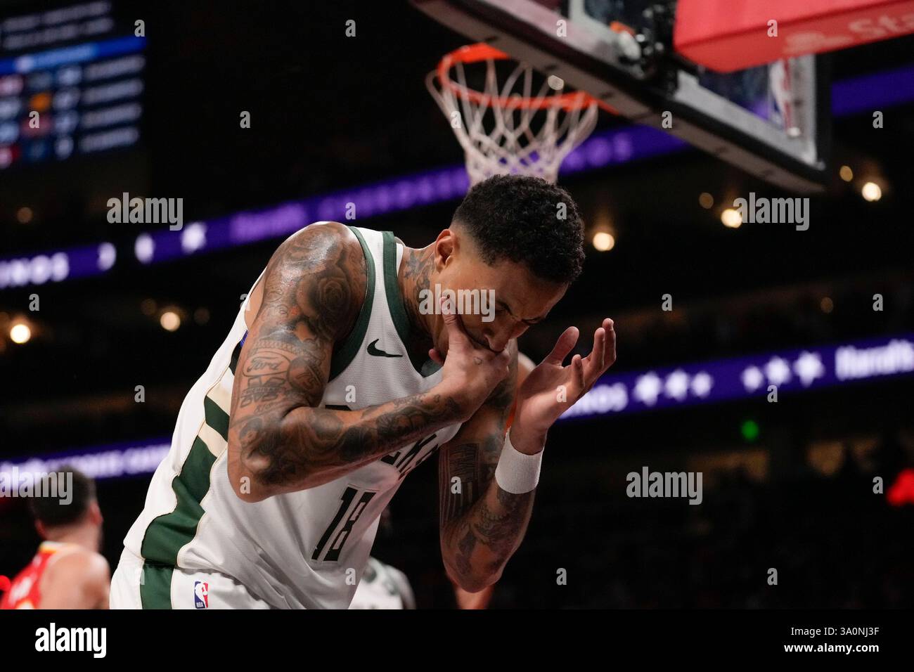 Milwaukee Bucks forward Kyle Kuzma (18) reacts to an injury in the ...