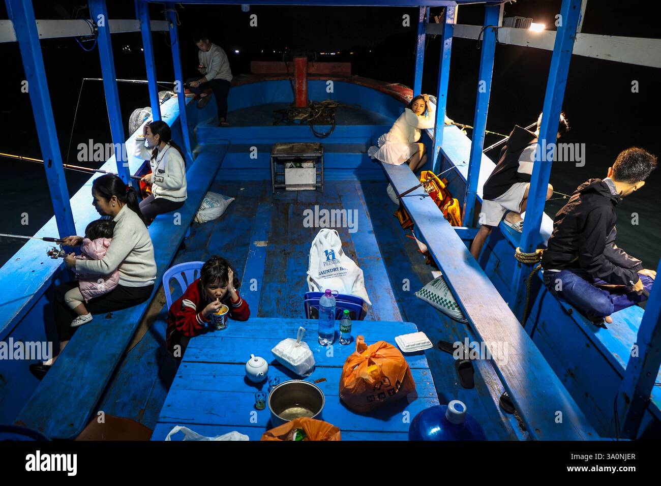 Members of the Tran family fish off Hon Tam Island on Feb. 7, 2025, in ...