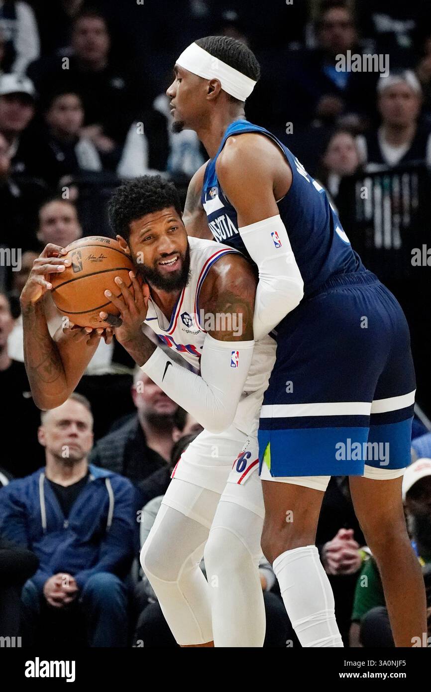 Minnesota Timberwolves forward Jaden McDaniels, right, forces a jump ...
