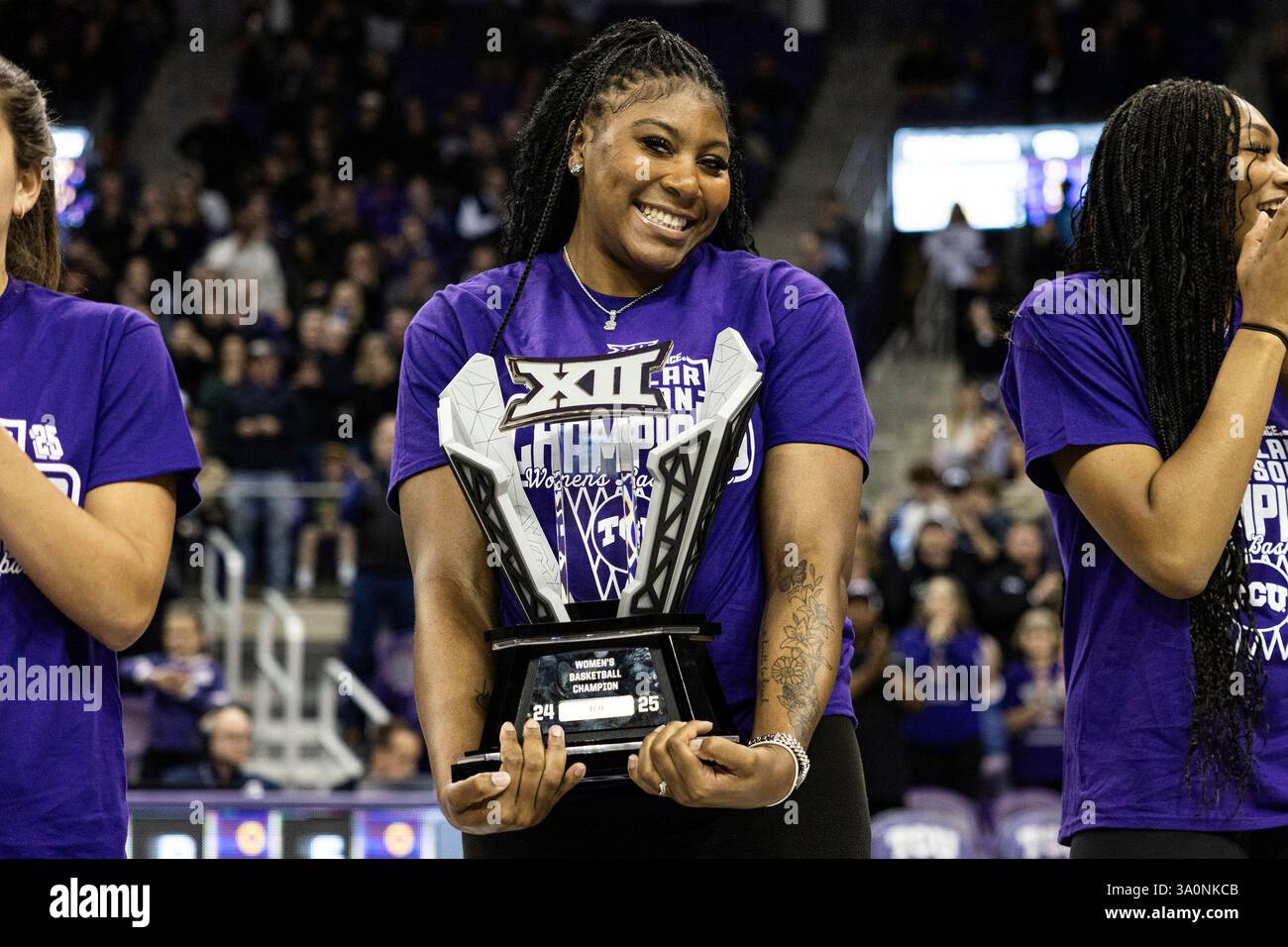 TCU forward Deasia Merrill holds the Big XII Championship trophy while ...