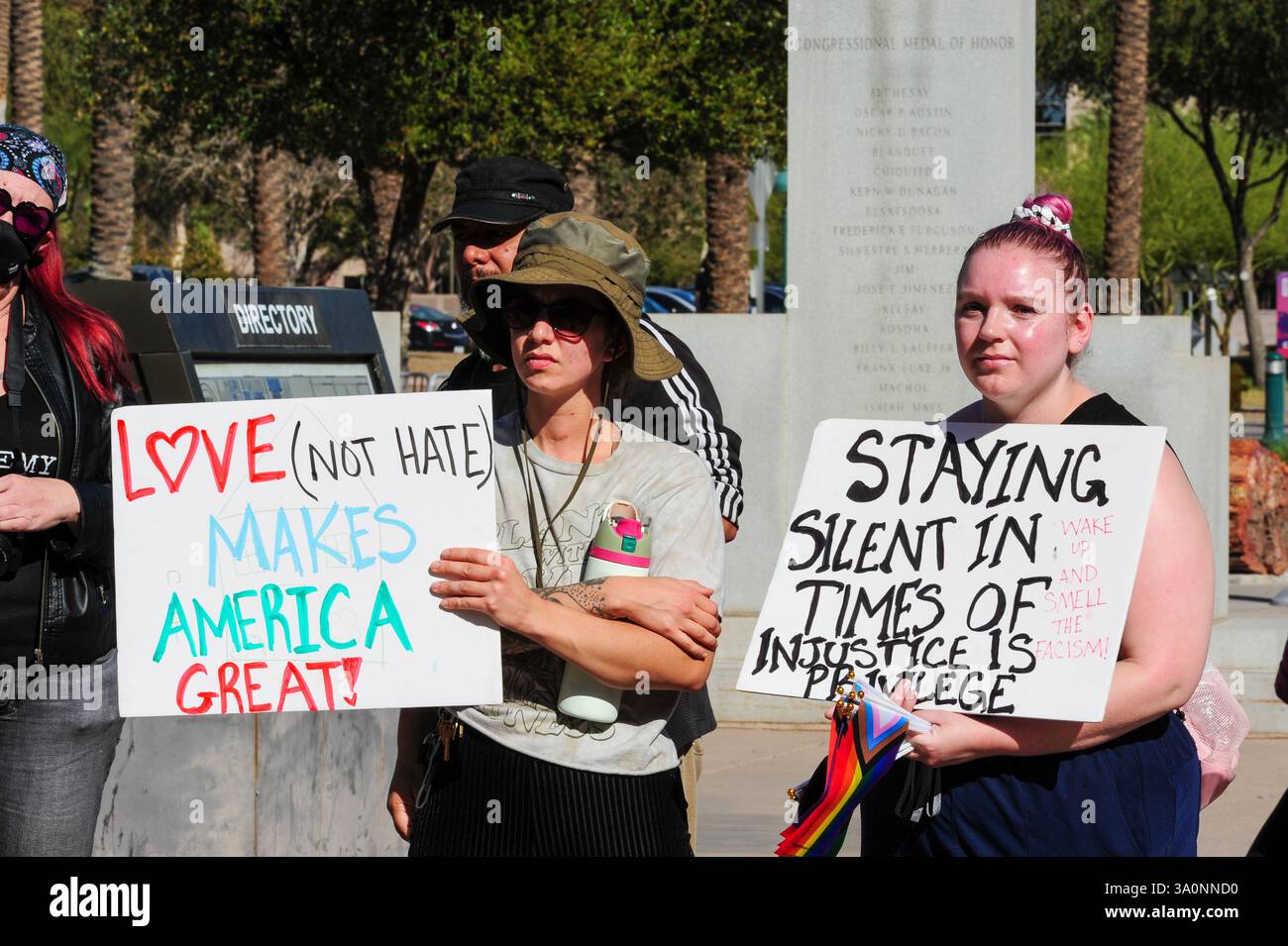 Phoenix, Arizona, USA. 4th Mar, 2025. Protesters hold signs promoting ...