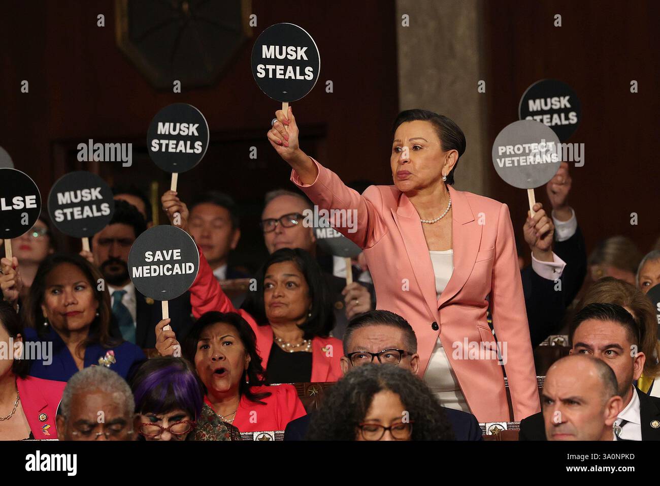 Rep. Nydia Velazquez, D-N.Y., holds a protest sign with fellow ...
