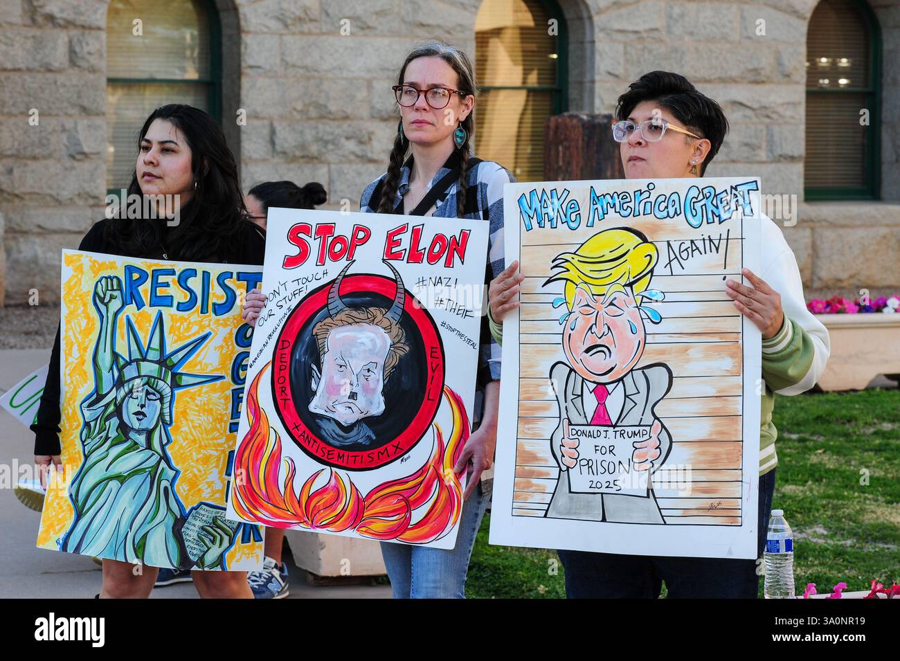 Phoenix, Arizona, USA. 4th Mar, 2025. Protesters hold illustrated signs ...