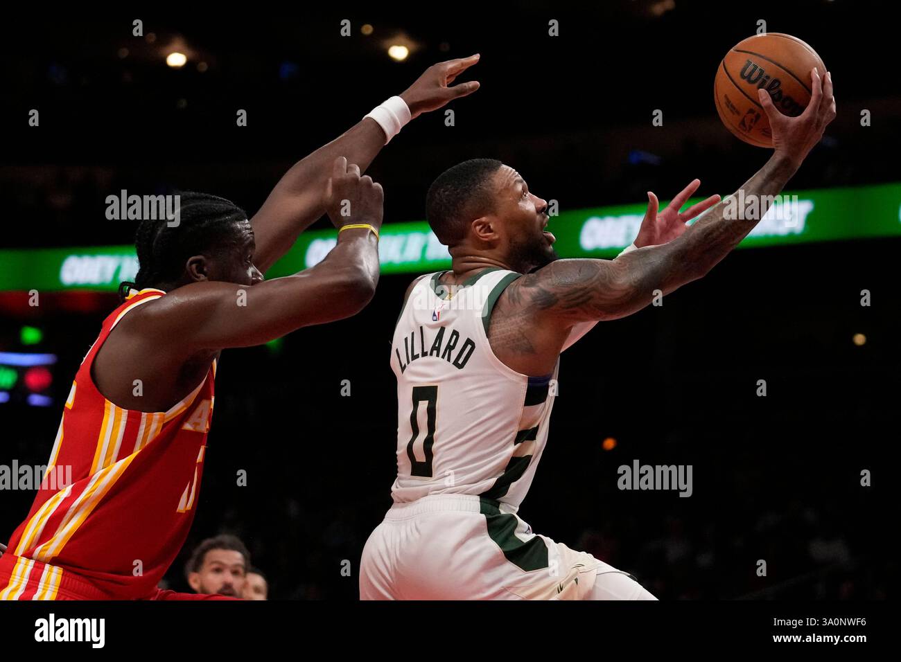 Milwaukee Bucks guard Damian Lillard (0) shoots against Atlanta Hawks ...