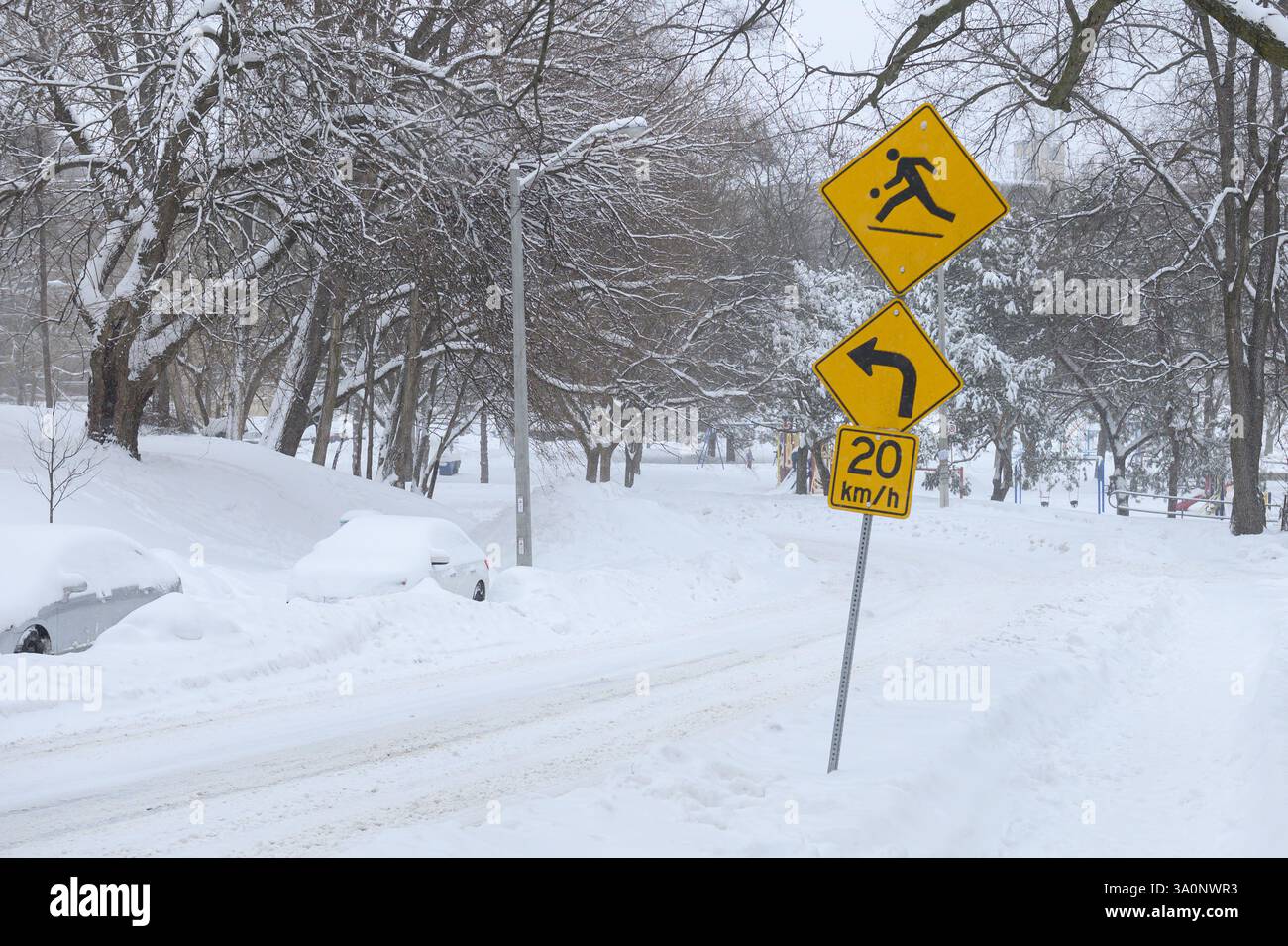 Toronto, ON, Canada - February 27, 2025: A yellow pedestrian warning ...