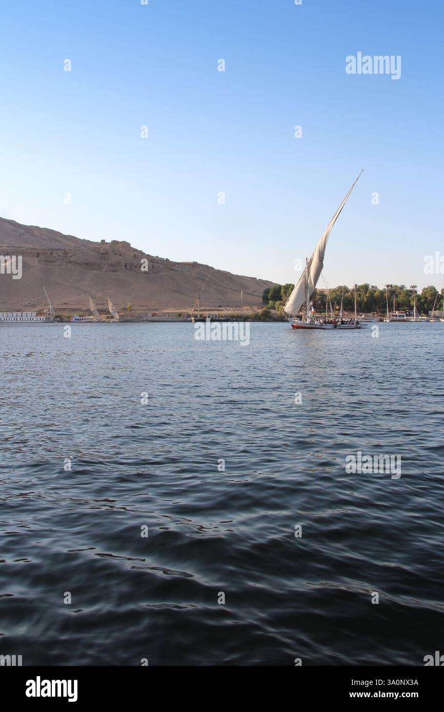 Felucca sailing on Nile River during sunset at Aswan, Egypt Stock Photo ...