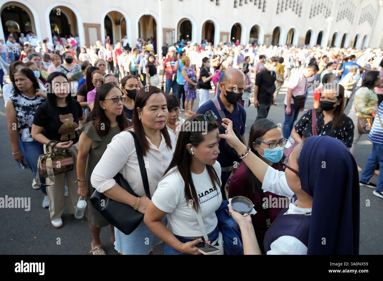 Devotees are marked with an ash cross on their foreheads during Ash ...