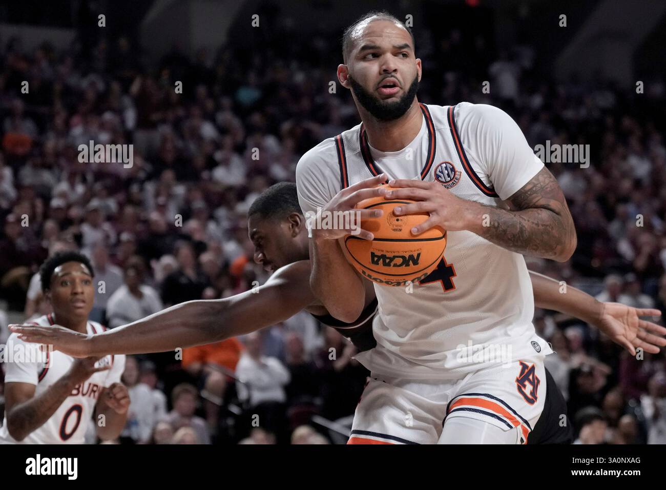 Auburn forward Johni Broome, front, grabs a rebound away from Texas A&M ...