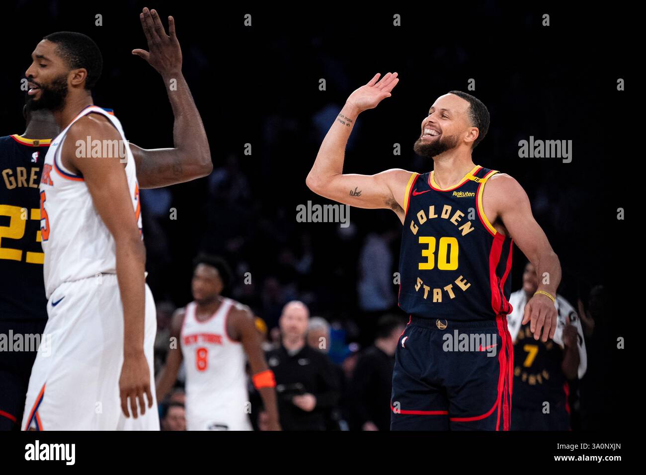Golden State Warriors guard Stephen Curry (30) high-fives his teammate ...
