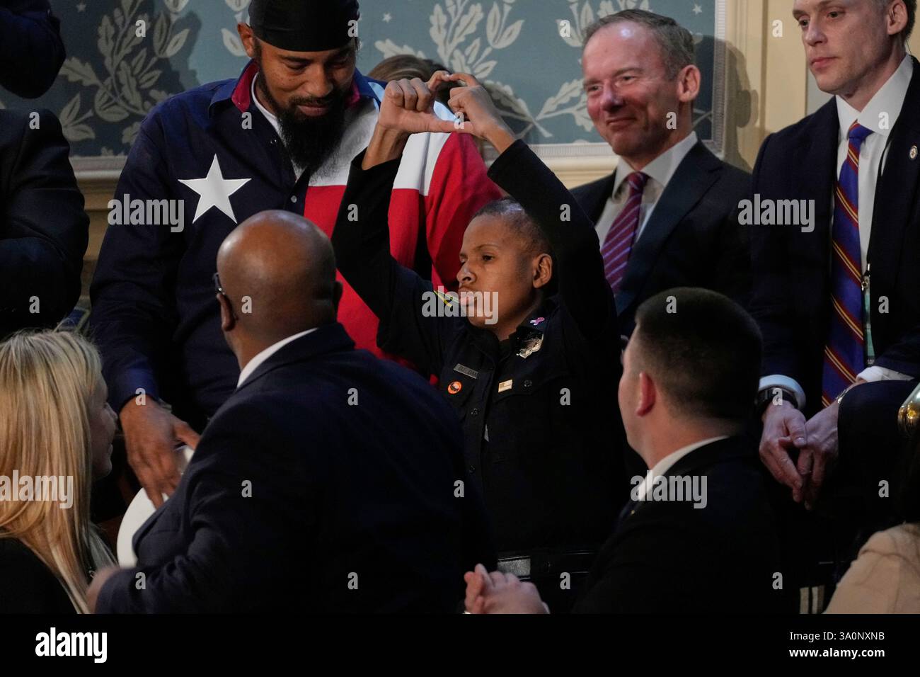 Devarjay "DJ" Daniel makes a heart sign with his hands as President ...