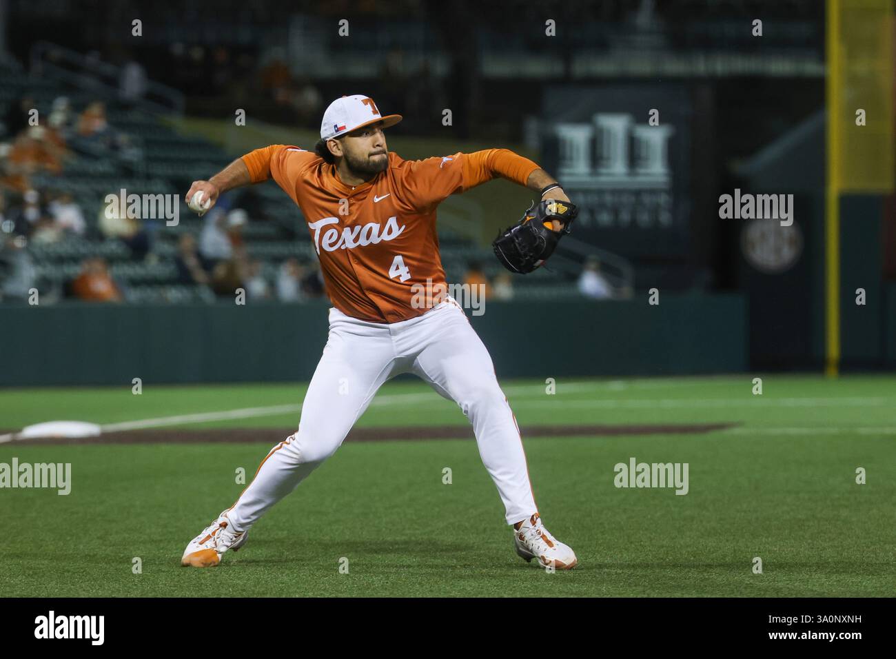 AUSTIN, TX - MARCH 04: Texas pitcher Jason Flores (4) fields a ground ...