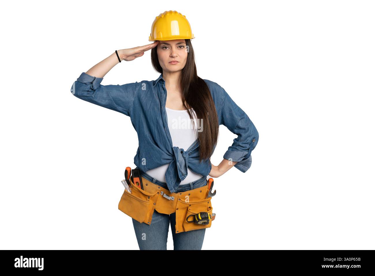 A determined female construction worker in a denim shirt and tool belt ...