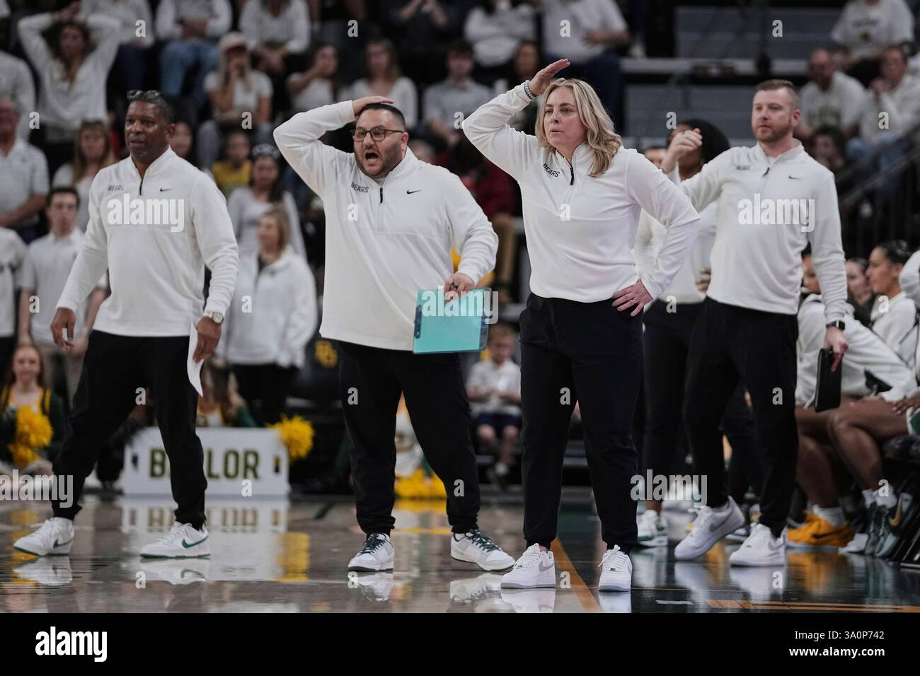 Baylor head basketball coach Nicki Collen, center, and her staff react ...