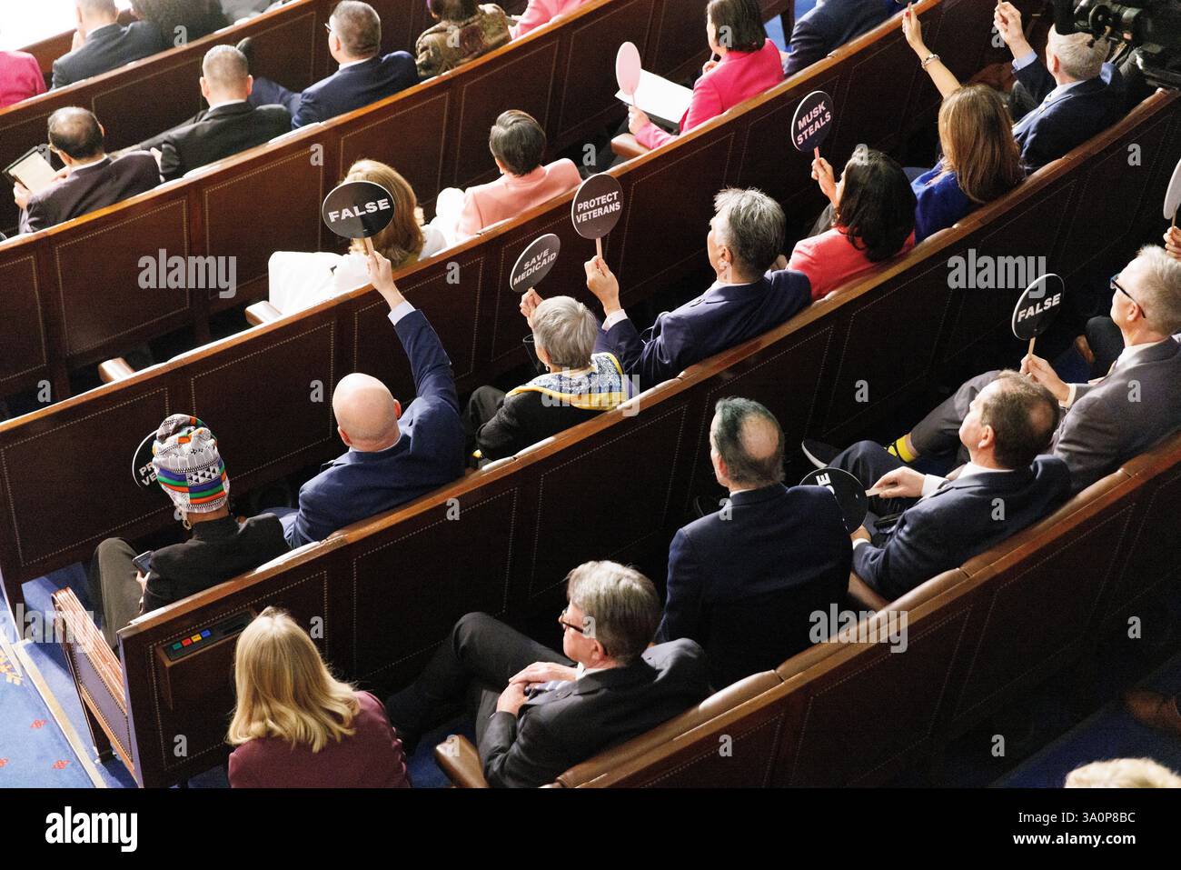 Democrats hold signs in protest as US President Donald J. Trump gives ...