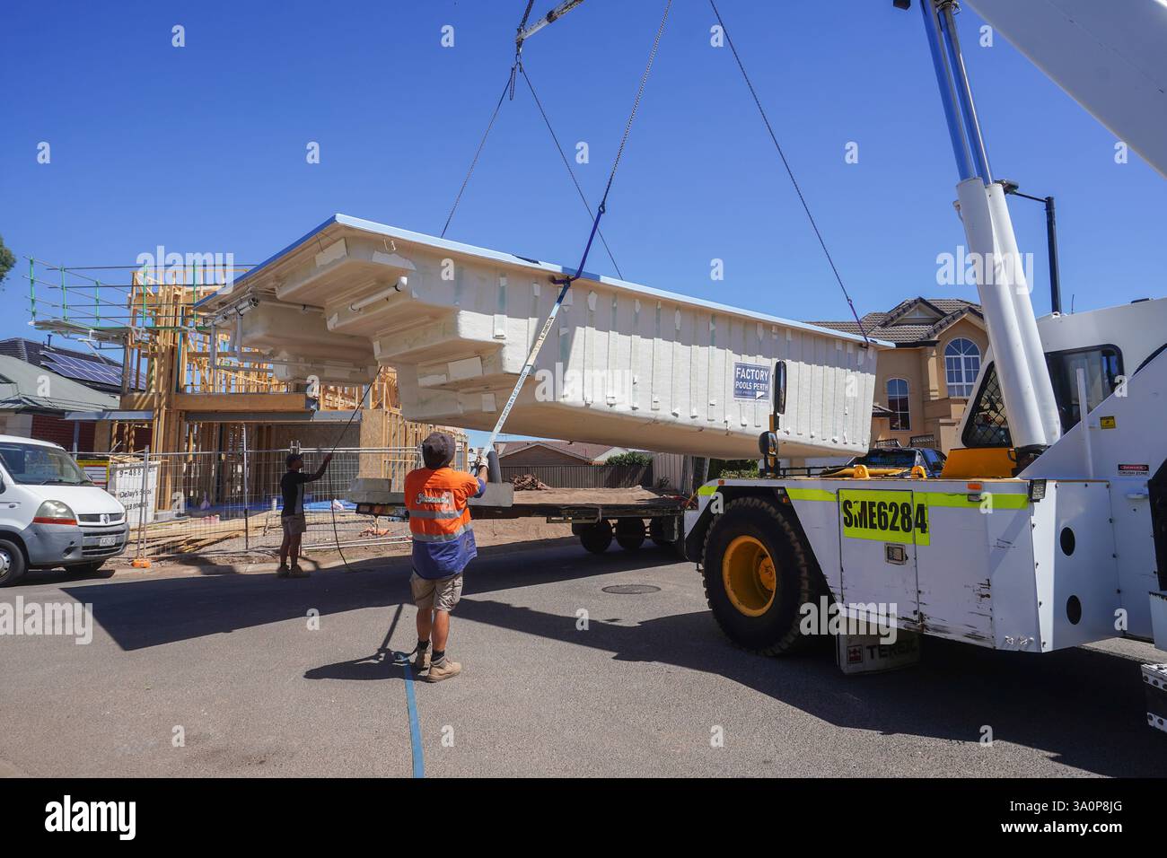 Adelaide, Australia 5 March 2025. A crane lifting a fiberglass swimming ...
