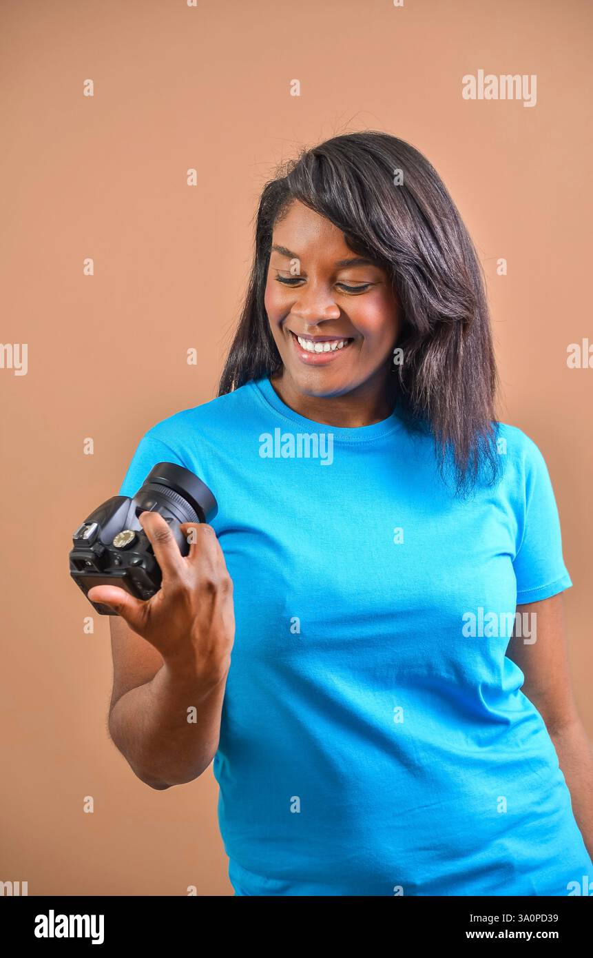 Happy photographer reviewing photos on camera, enjoying photography work Stock Photo - Alamy