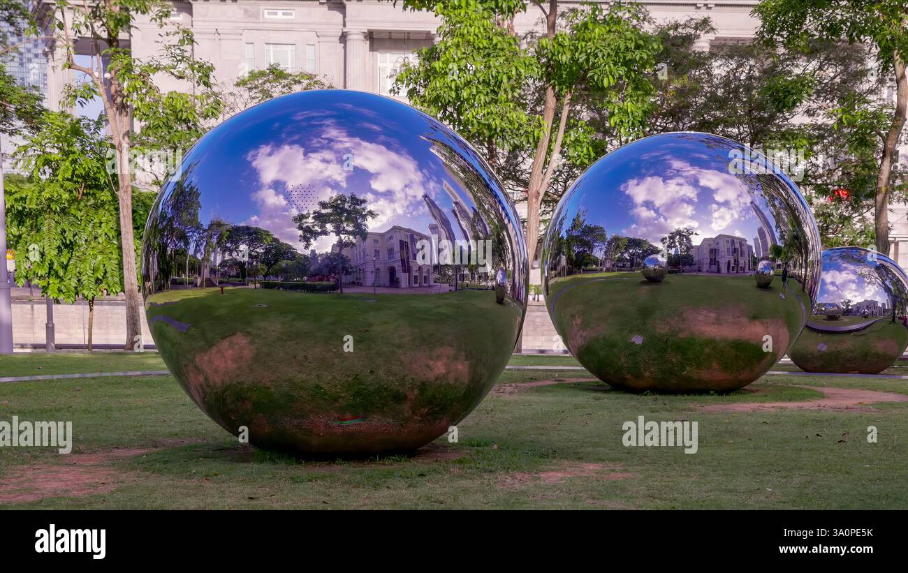 an art installation of three large mirror balls in singapore Stock ...