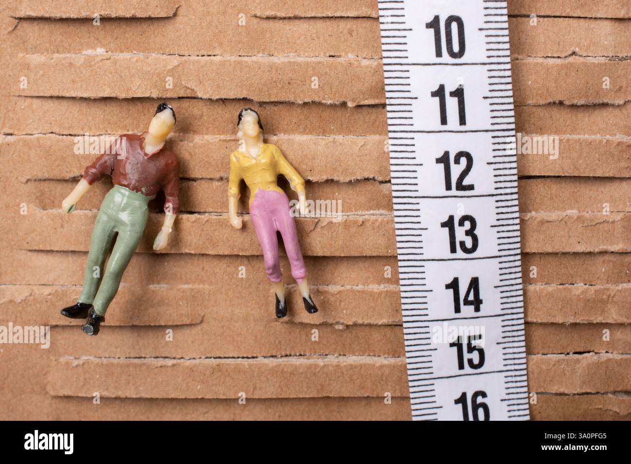Man and Woman figurine and soft measuring tape. tape measure with ...