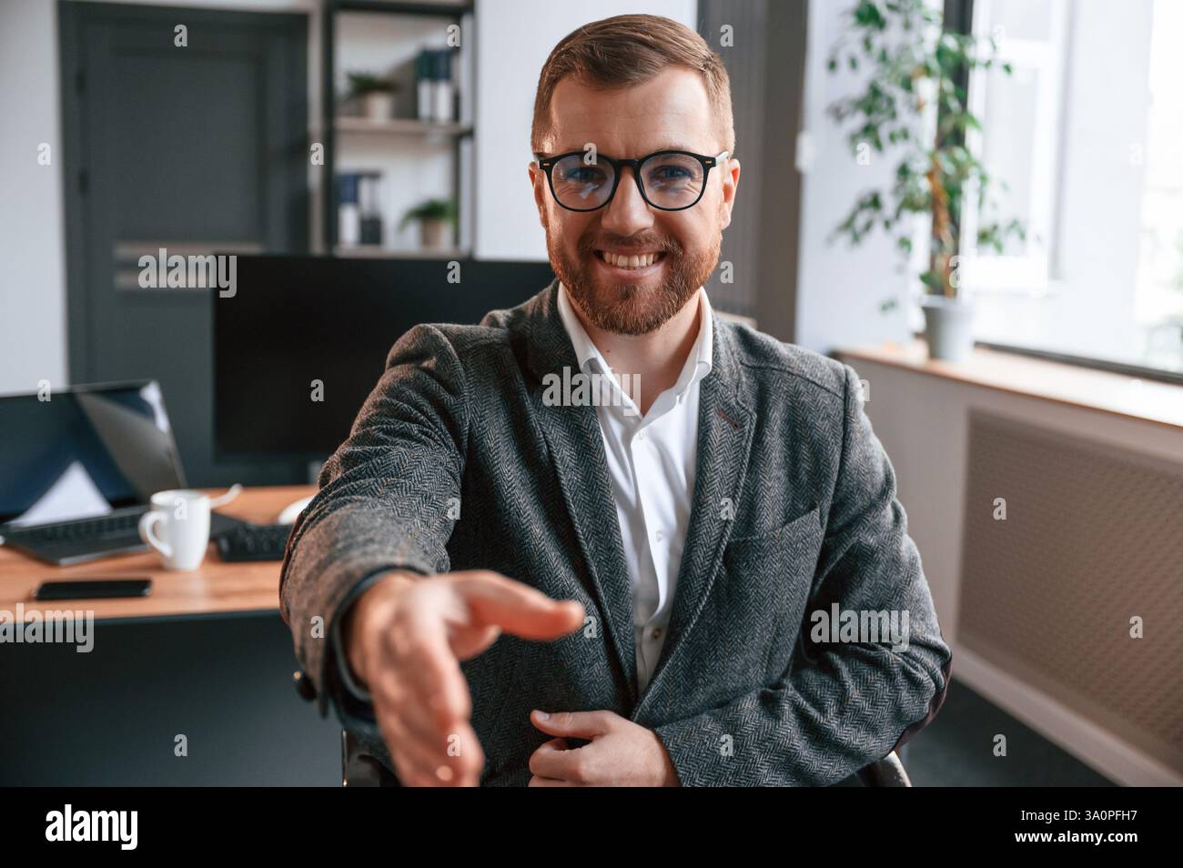 Giving the hand, greetings gesture. Businessman in suit is in the ...