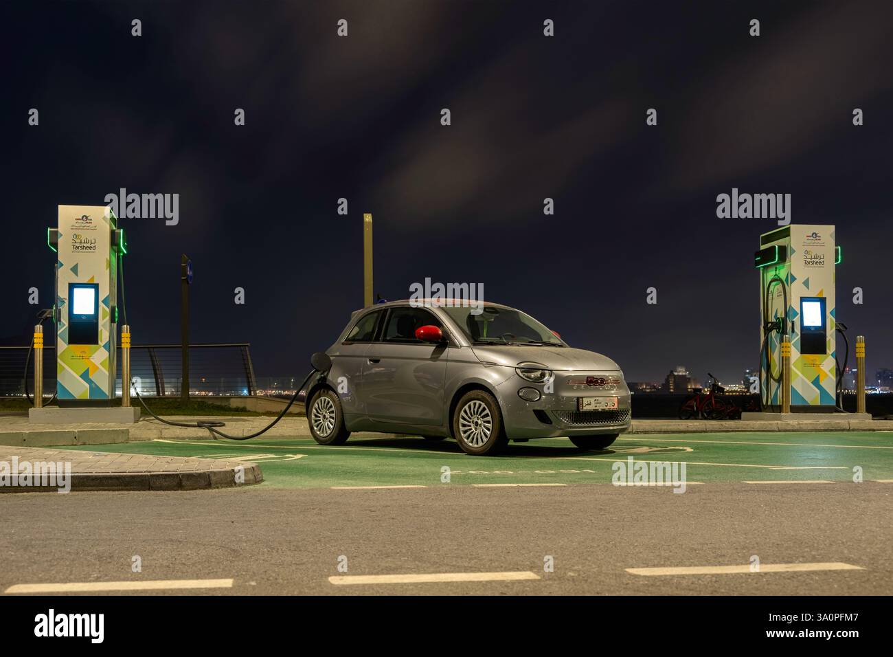 A grey 2022 Fiat 500 EV electric car at EV station. Electric vehicle using sustainable source ...