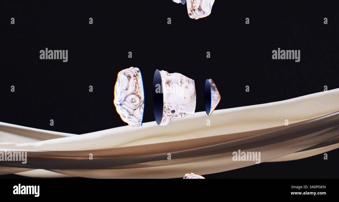 Image of ancient sculpture heads falling over beige fabric on black ...