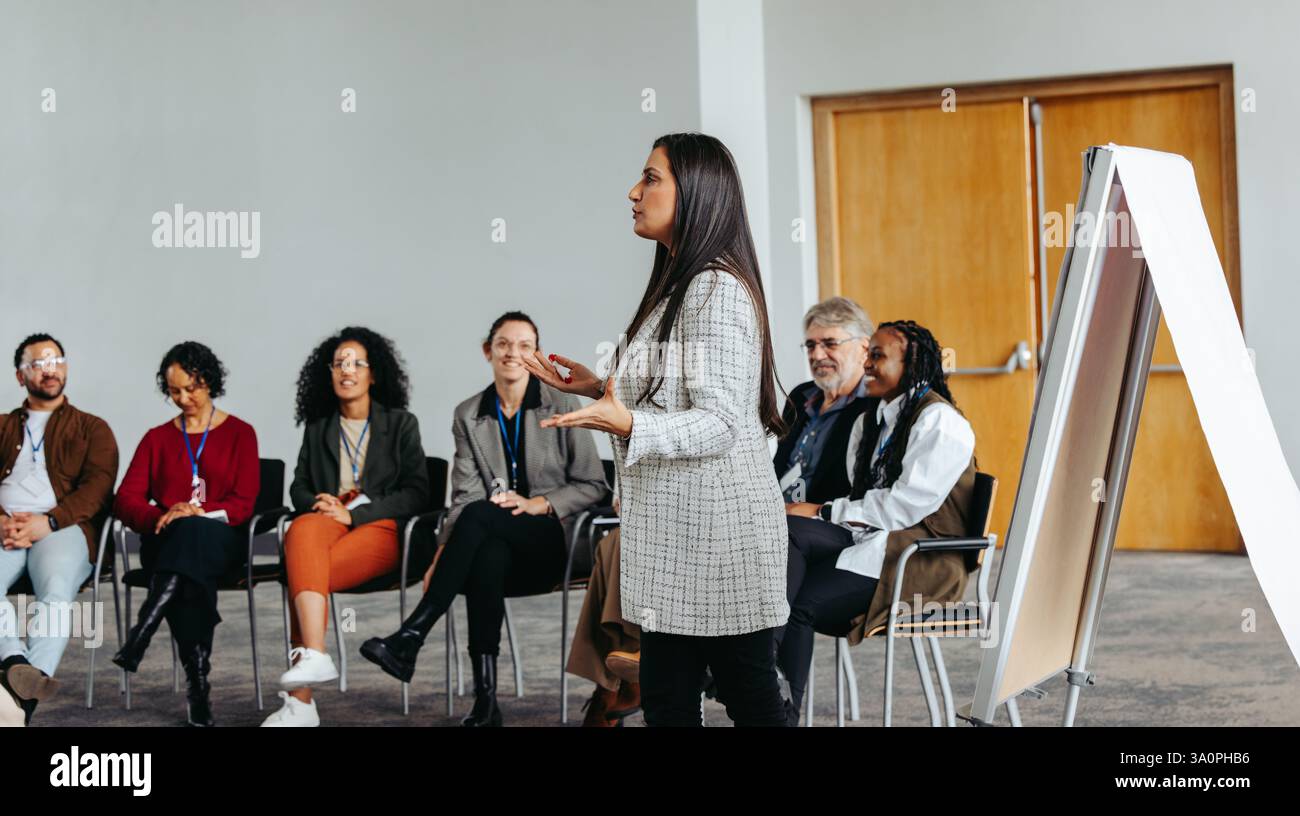 A female instructor engaging with a diverse team in a teambuilding ...